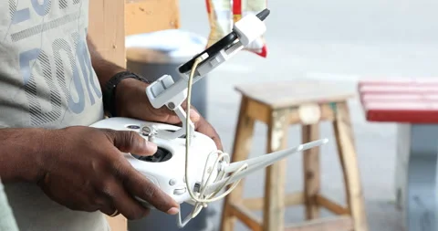 Hands Holding Remote Controlling Robot | Stock Video | Pond5