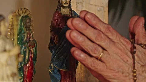 Hands Of Lady Praying Rosary And Statues... | Stock Video | Pond5