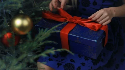 hands of a little girl untie a bow on a ... | Stock Video | Pond5