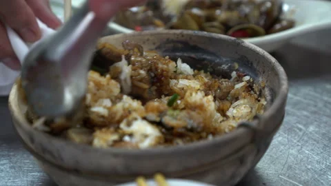 Hands mixing eel fish clay pot baked ric... | Stock Video | Pond5