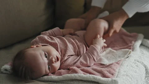 Hands Moving Legs of Baby | Stock Video | Pond5