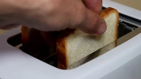 Hands put toast bread in toaster in the ... | Stock Video | Pond5