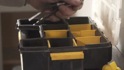Hands reach into toolbox to grab tools. | Stock Video | Pond5