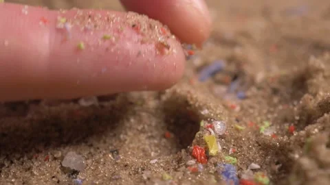 hands showing microplastics on the beach... | Stock Video | Pond5