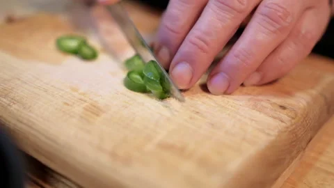 Hands slowly chopping chili pepper on cu... | Stock Video | Pond5