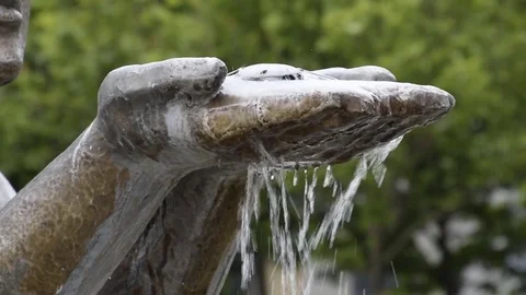 Hands statue from which water flows. | Stock Video | Pond5