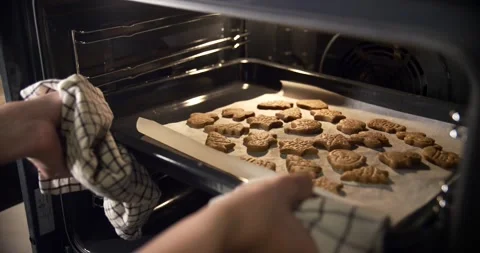 Hands take a baking sheet with cookies o... | Stock Video | Pond5