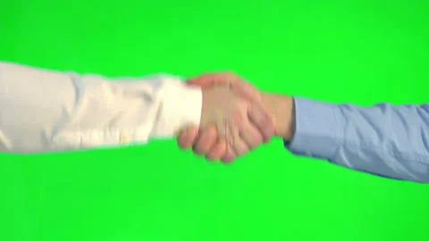 Handshake on a green background in 4k sl... | Stock Video | Pond5