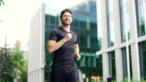 Handsome bearded male runner running on ... | Stock Video | Pond5