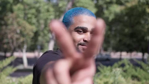 Handsome black man with blue hair sendin... | Stock Video | Pond5