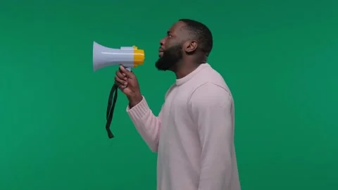 Handsome black man shouting by megaphone... | Stock Video | Pond5