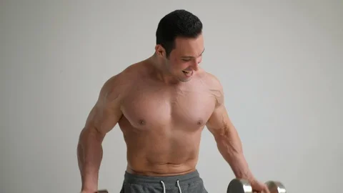 Handsome bodybuilder posing on white bac... | Stock Video | Pond5