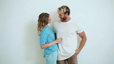 Handsome couple hugging in white studio | Stock Video | Pond5