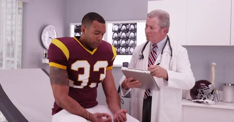 Handsome football player having doctor c... | Stock Video | Pond5
