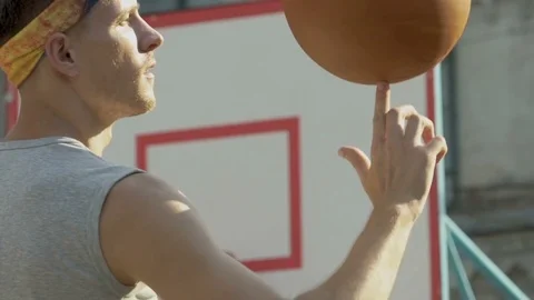 Handsome guy spinning basketball on his ... | Stock Video | Pond5
