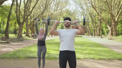 Handsome muslim guy using barbell for tr... | Stock Video | Pond5