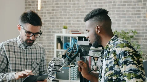 Handsome young men testing robot with ta... | Stock Video | Pond5