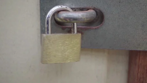 Hanging lock is closed on, close-up view | Stock Video | Pond5
