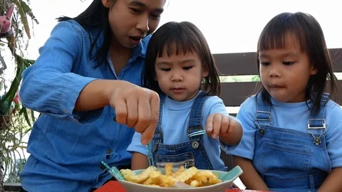 Happy Asian family eating french fries i... | Stock Video | Pond5
