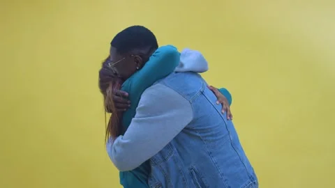 Happy black couple hug isolated on yello... | Stock Video | Pond5