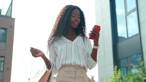 Happy black woman shopper walking on str... | Stock Video | Pond5