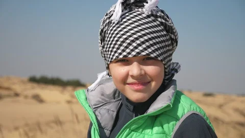 Happy boy in black and white shemagh sm... | Stock Video | Pond5