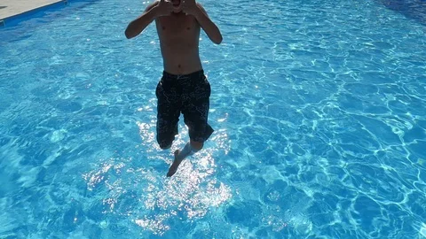 Happy boy jumps feet first and spins in ... | Stock Video | Pond5