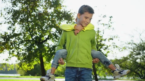Happy boy spinning around with brother o... | Stock Video | Pond5