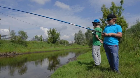 Happy boys go fishing on the river, Two ... | Stock Video | Pond5
