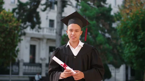 Happy charismatic graduate guy holding h... | Stock Video | Pond5