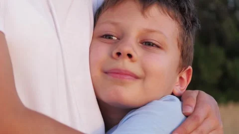 Happy child boy snuggles up to mother, h... | Stock Video | Pond5