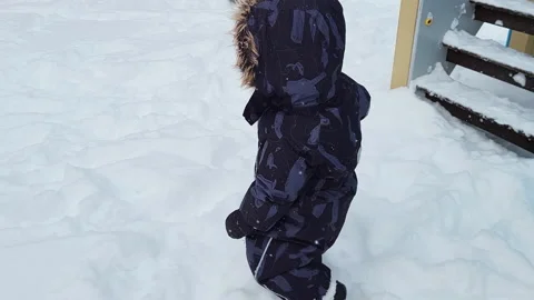 A happy child is drowning in deep snow w... | Stock Video | Pond5