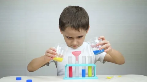 A happy child plays with chemical experi... | Stock Video | Pond5