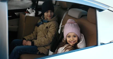 happy children in back seat of auto, saf... | Stock Video | Pond5