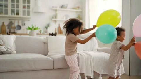 Happy children fighting by balloons, Afr... | Stock Video | Pond5