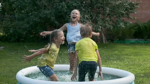 Happy children jump in an round pool on ... | Stock Video | Pond5