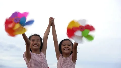 happy children playing colorful pinwheel... | Stock Video | Pond5