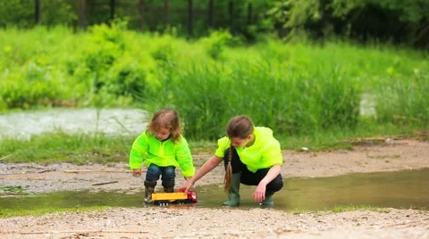 Happy Children Playing In Puddle At Gree... | Stock Video | Pond5