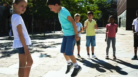 Happy children playing rubber band jumpi... | Stock Video | Pond5