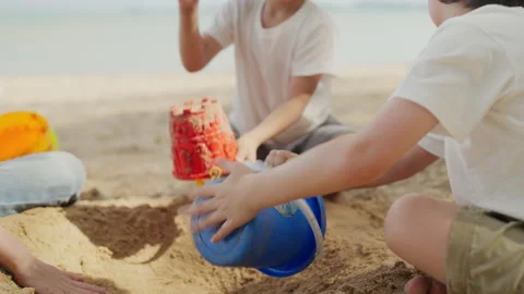 Happy children playing sand together on ... | Stock Video | Pond5