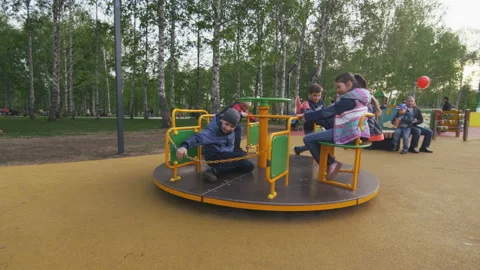 happy children rotate on bright carousel... | Stock Video | Pond5
