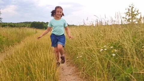 Happy children run along the path in the... | Stock Video | Pond5