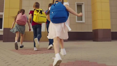 Happy children with school backpacks run... | Stock Video | Pond5