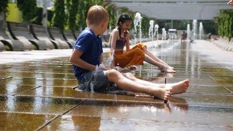 Happy children sit on concrete slabs in ... | Stock Video | Pond5