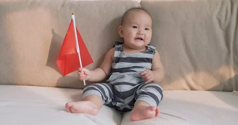 Happy Chinese baby holding China flag | Stock Video | Pond5