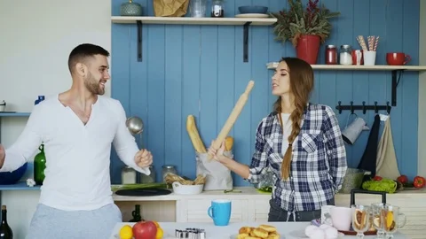 Happy couple having fun in the kitchen f... | Stock Video | Pond5