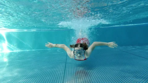 Happy cute child joyfully diving and pla... | Stock Video | Pond5