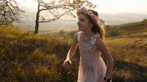 Happy cute girl running in the meadow. A... | Stock Video | Pond5