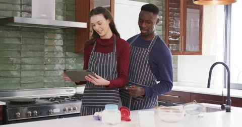 Happy diverse couple standing in kitchen... | Stock Video | Pond5