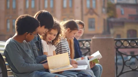 Happy diverse school children reading bo... | Stock Video | Pond5